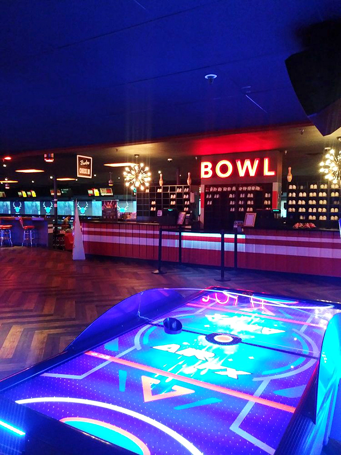 The retro-modern "BOWL" sign glows like a beacon of fun, while neat rows of bowling shoes await their next adventure. 