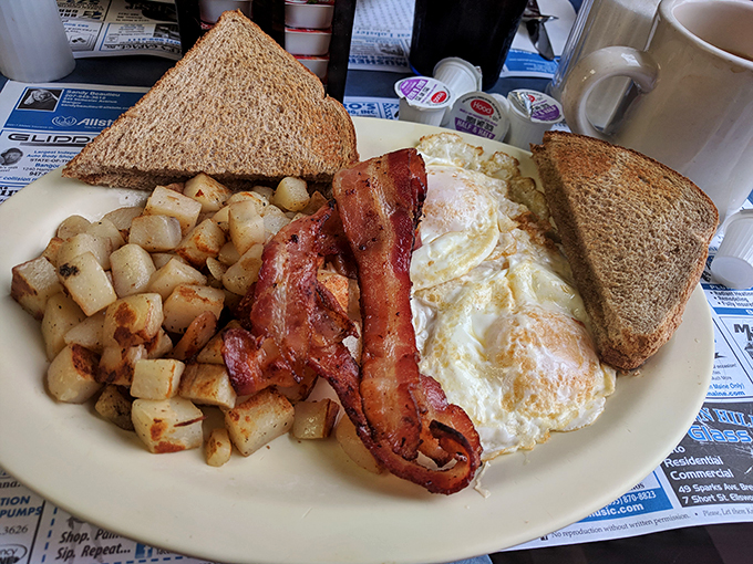 Bacon, eggs, toast, and crispy potatoes—classic diner joy! It’s like breakfast gave you a hug and said, 'Welcome home!