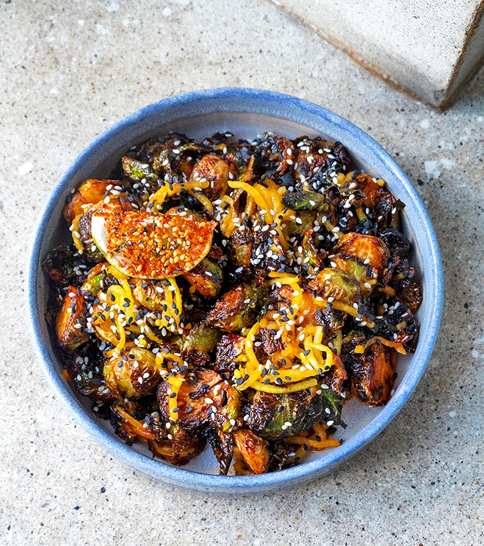 These aren't your grandmother's Brussels sprouts – they're caramelized, Asian-inspired flavor bombs topped with sesame.