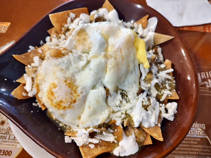 Another angle on breakfast bliss: Chilaquiles swimming in verde sauce, crowned with perfectly poached eggs. Photo credit: Carlos Leyva