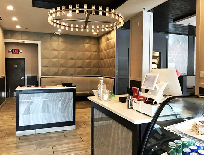 Modern meets elegant at the front counter, where that stunning chandelier steals the show like a Broadway star.