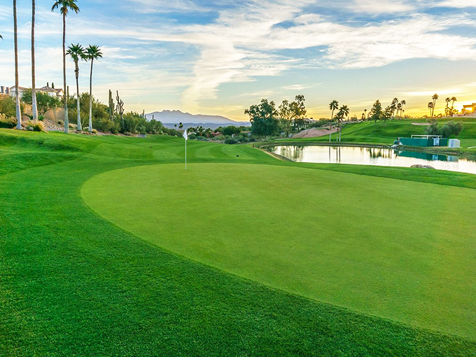 As the sun sets over the mountains, the golf course transforms into a golden canvas of shadow and light.