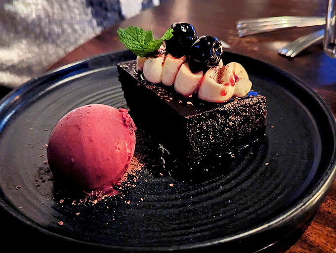 A slice of midnight-dark chocolate cake meets berry sorbet in a dessert that's dressed to impress. Photo credit: Thomas Martellone
