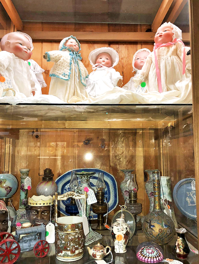 These vintage dolls in pristine white dresses seem to whisper tales from nurseries of generations past. 