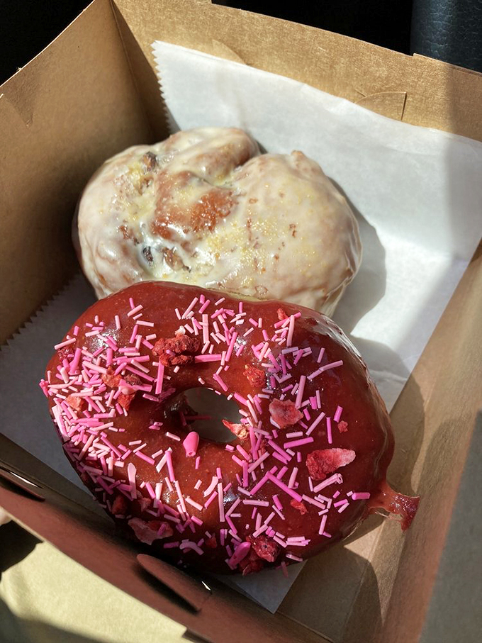 Pink sprinkles and golden glaze make these donuts look like they're dressed for a party in your mouth.