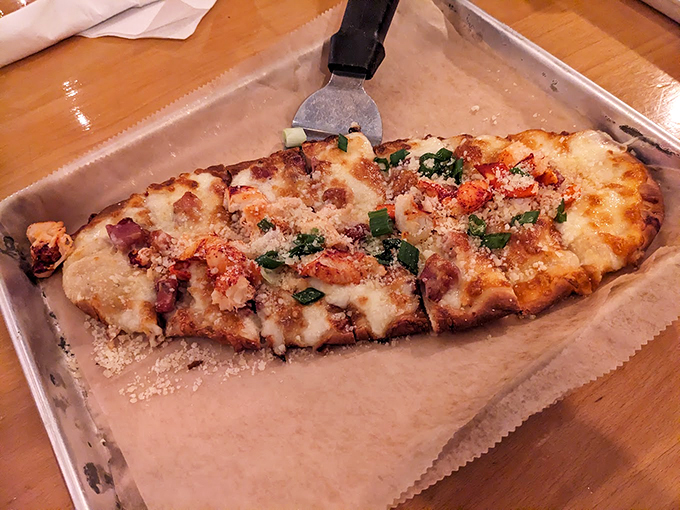 This flatbread is a canvas of culinary creativity, topped with seafood and fresh herbs that tell a delicious coastal story. Photo credit: Daniel "TheOldNorthWind" Jones