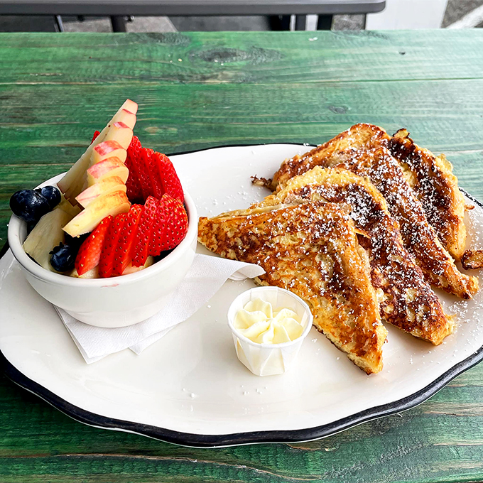 Golden-brown French toast shares the plate with fresh fruit - breakfast doesn't get more picture-perfect than this.