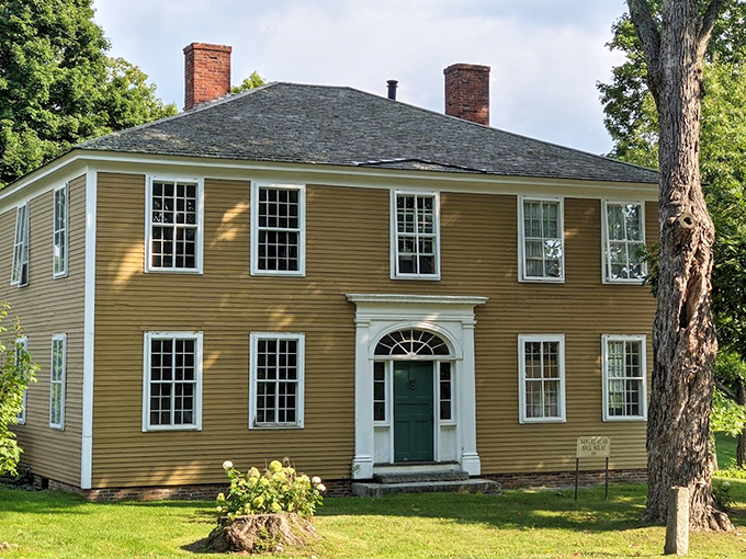 The Samuel Read Hall House stands proudly in its mustard-yellow glory, a testament to early American architectural elegance.