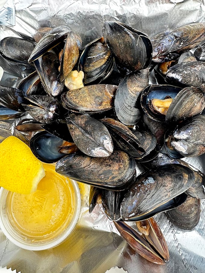 These plump mussels are ready for their moment, glistening with promise and paired with that essential squeeze of lemon.