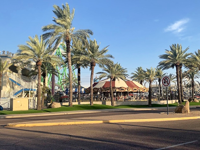 An oasis of fun! Castles N' Coasters stretches out before you, a colorful tapestry of rides and attractions under the Arizona sky.