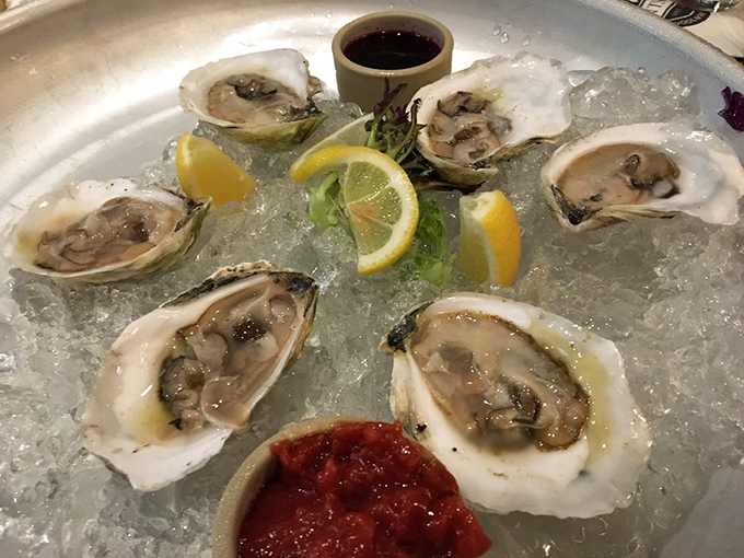 Fresh-shucked treasures from the cold Maine waters, arranged like pearls on a bed of ice.
