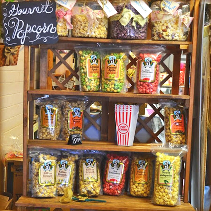 Gourmet popcorn lines rustic shelves like a parade of flavor, each bag promising a perfect movie night companion.