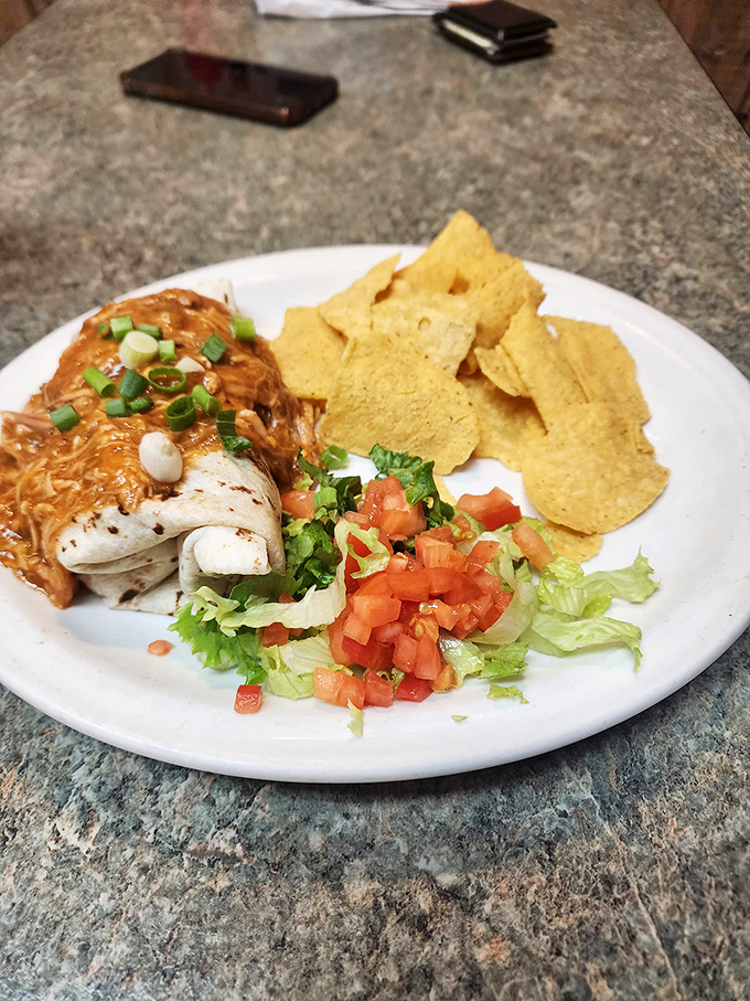 Wrap your hands around happiness. These pork green chili burritos are like a warm, spicy hug from your abuela &ndash; if she were a chef. Photo credit: Beeline Cafe