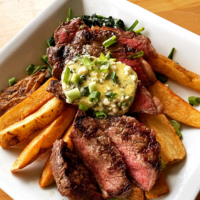 A perfectly cooked steak with hand-cut fries and compound butter that makes every bite worth savoring. Photo credit: Alisson's Restaurant