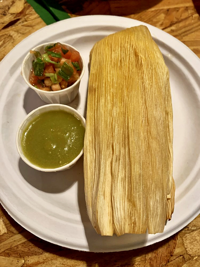 Wrapped like a present in its corn husk blanket, this tamale comes with fresh salsa and green sauce for extra excitement.
