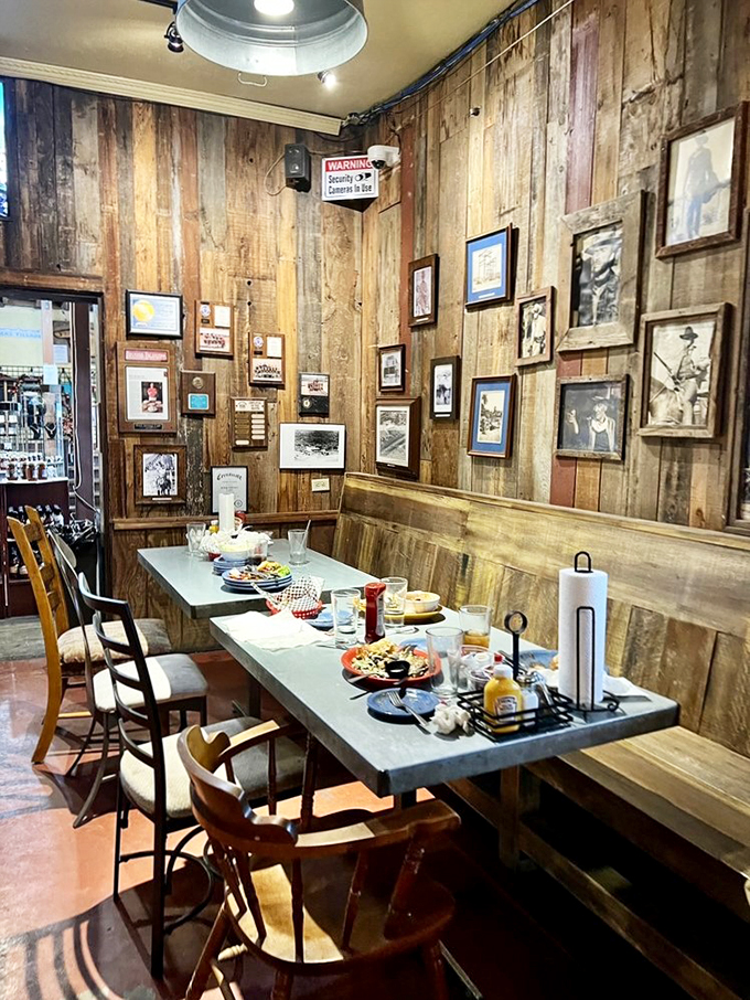 Rustic wooden walls adorned with vintage photographs create the perfect backdrop for memorable meals.
