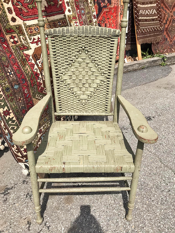 This sage-green woven rocker looks ready to tell tales of front porch conversations from generations past.