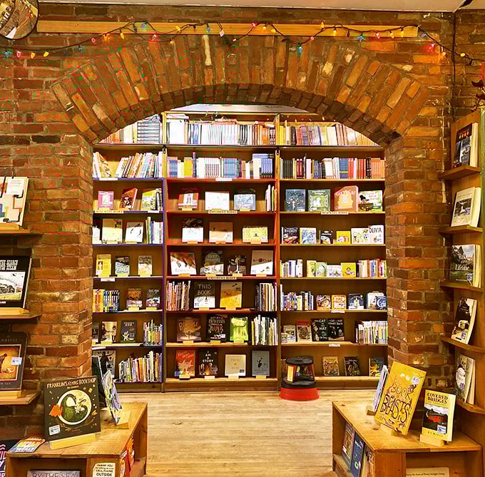 Warm lighting and wooden shelves create an inviting atmosphere that whispers, "Stay a while, read a chapter or ten." Your to-do list can wait!