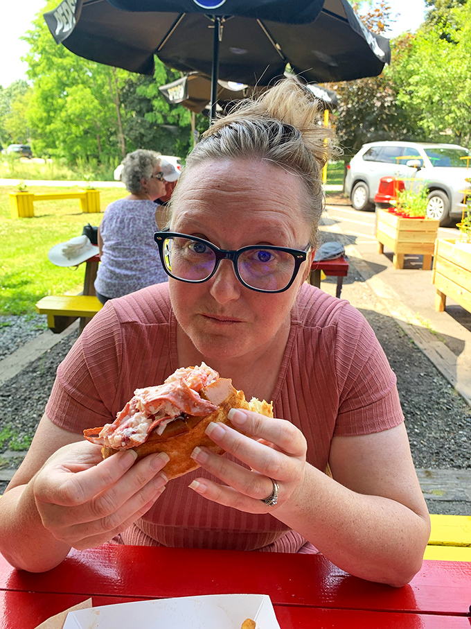 Pure joy captured in a single bite, this diner's expression says everything you need to know about how good these sandwiches actually taste when they hit your taste buds.