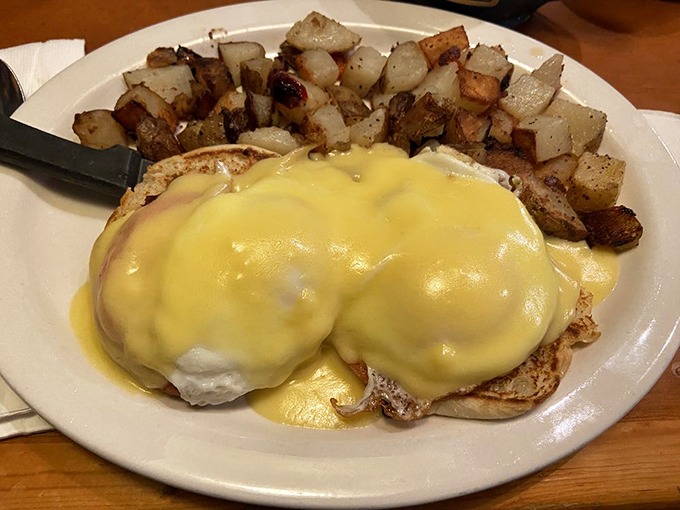 Hollandaise heaven! This Eggs Benedict is stacked higher than your to-read pile of books.
