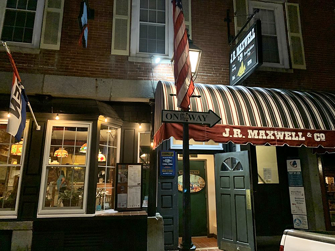 A warm glow of welcome! As night falls, J.R. Maxwell & Co. lights up like a lighthouse, guiding hungry souls to a safe harbor of deliciousness.