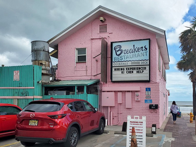 The exterior view showcases that unmistakable pink façade – like a sunburned tourist who's having too much fun to care.