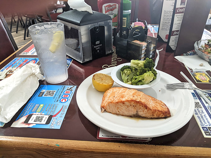 Salmon that swam upstream and straight into flavor town! This perfectly grilled fillet is making waves on a sea of steamed broccoli. Photo credit: PAUL R GALIPEAU