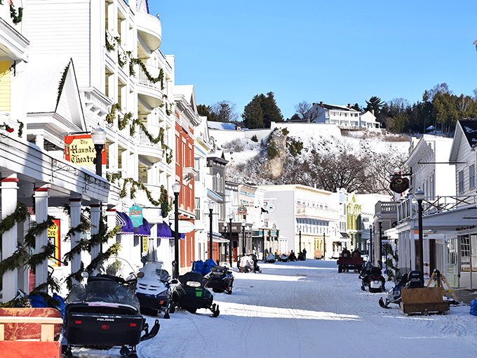 Snowmobiles lined up like Santa's reserve reindeer, ready to dash through the snow (no sleigh required).