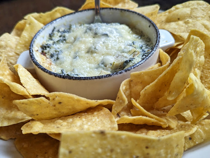 Chip, chip hooray! This creamy spinach dip, surrounded by a sea of crispy tortilla chips, is the life of any party.