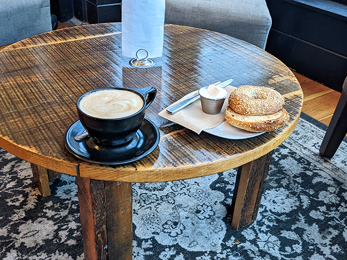 The perfect trifecta: a steaming latte, a fresh bagel, and a cozy corner. It's not just breakfast&mdash;it's the start of a beautiful friendship with your taste buds.