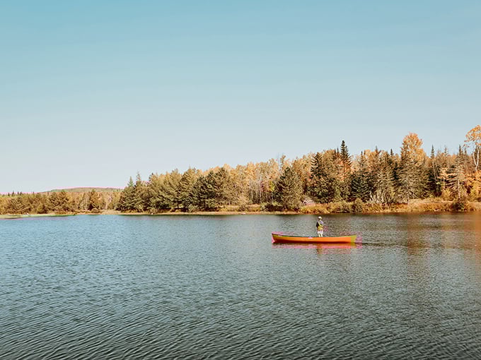 Serenity now! This lone paddler on Moosehead Lake is living everyone's dream of peace, quiet, and stunning fall colors. No filter needed for this Instagram-worthy moment.
