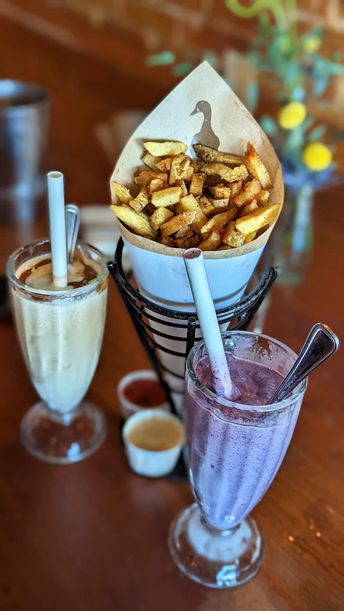 The holy trinity of Duckfat: crispy fries, creamy shakes, and whatever that purple potion is. It's a flavor fiesta that'll make your taste buds break out the tiny sombreros.