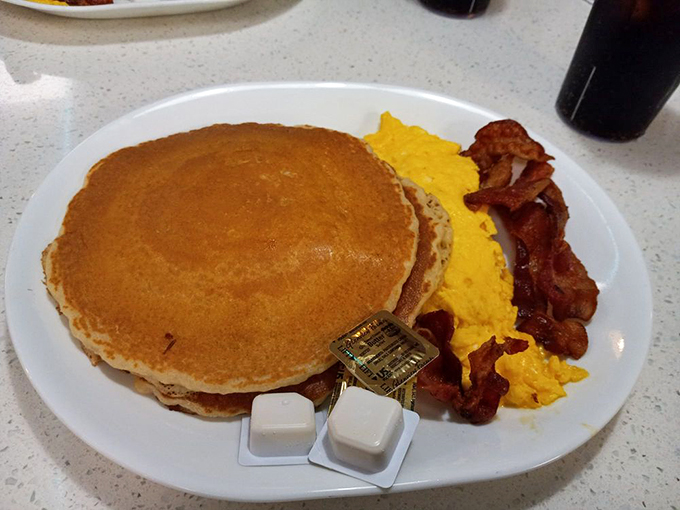 Pancakes so big, they should come with their own zip code! Golden, fluffy, and ready to soak up more syrup than a sponge at sea.