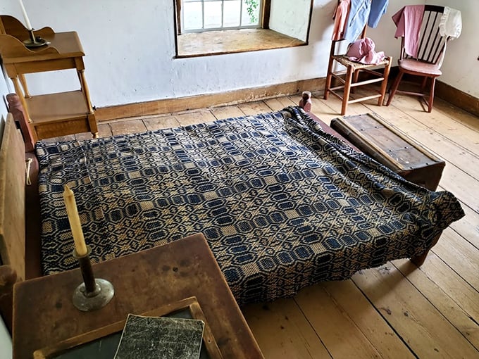 A simple bed with an intricate coverlet reminds us that comfort never goes out of style, even after two centuries.