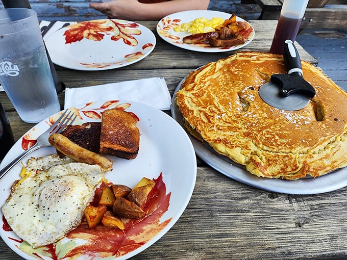 The breakfast spread that dreams are made of – eggs, toast, and yes, that's another giant pancake stealing the show.
