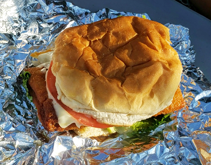This fish sandwich, nestled in its foil throne, proves that sometimes the simplest things make the biggest splash.