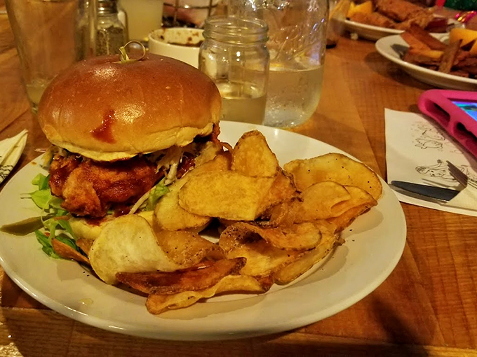 This isn't just any burger &ndash; it's a tower of temptation with house-made chips that crackle with possibility. Photo credit: Sinjan De
