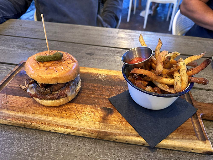 The burger arrives like a champion, with golden fries standing guard - comfort food elevated to an art form. Photo credit: Felicia M.