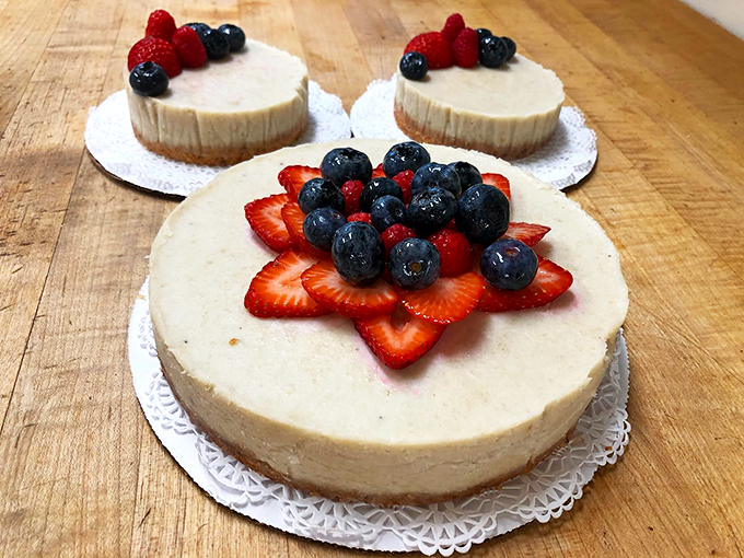 Fresh berries crown these pristine cheesecakes like jewels in a baker's crown.