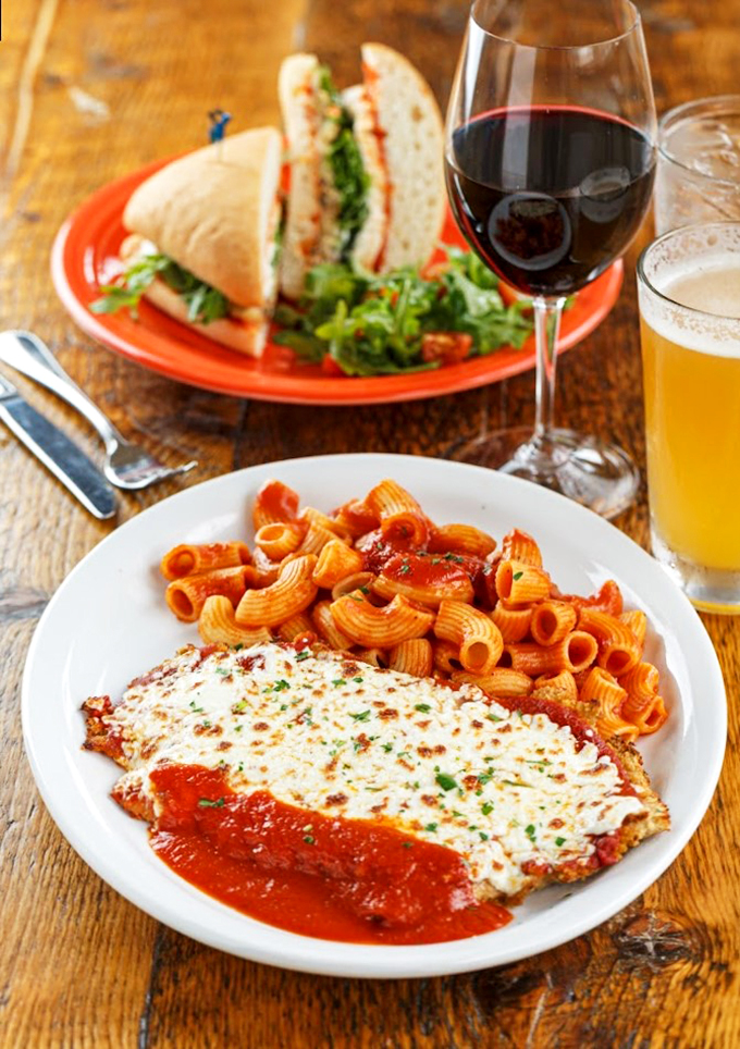The chicken parm that launched a thousand sighs, accompanied by pasta that's dressed better than most wedding guests.