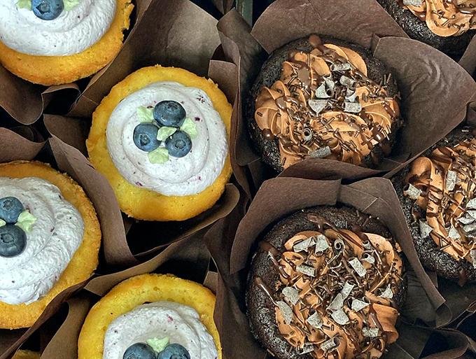 Cupcakes that look like they graduated from pastry school with honors - blueberry cream and chocolate decadence. Photo credit: Beach Pea Baking Co