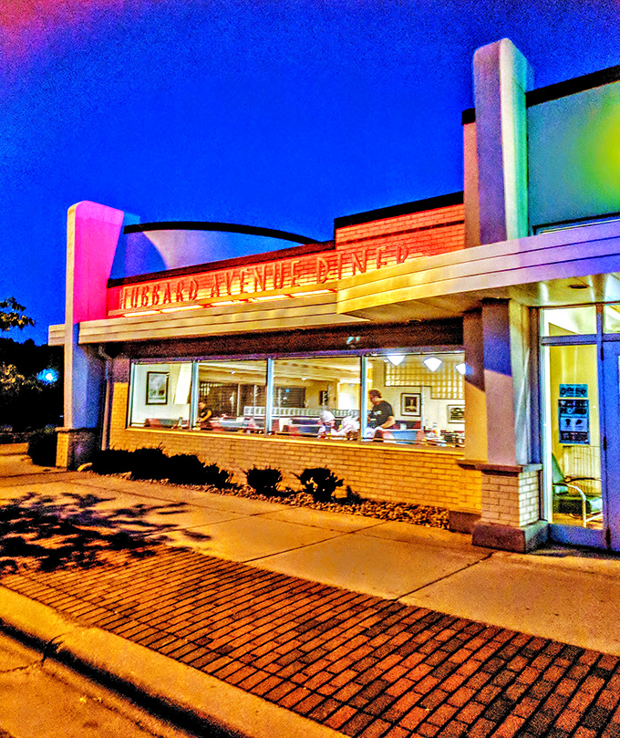 Diner by day, retro wonderland by night! This neon-lit facade isn't just a building; it's a beacon of nostalgia in a sea of modern monotony.