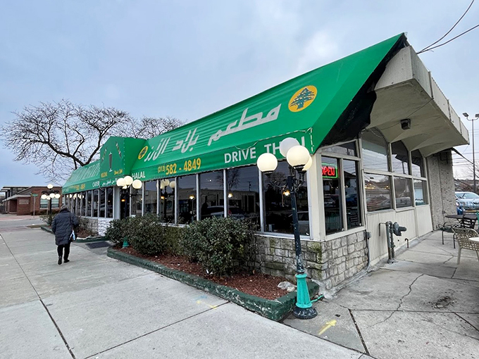 The green-trimmed facade glows like an oasis in the evening light, welcoming hungry visitors to a Middle Eastern adventure.