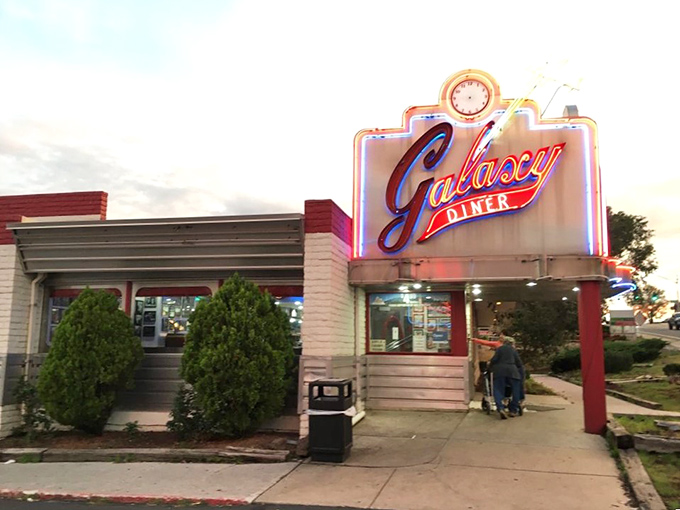 Welcome to flavor town, population: you! The Galaxy Diner's entrance promises a journey through time, taste, and possibly your belt size.