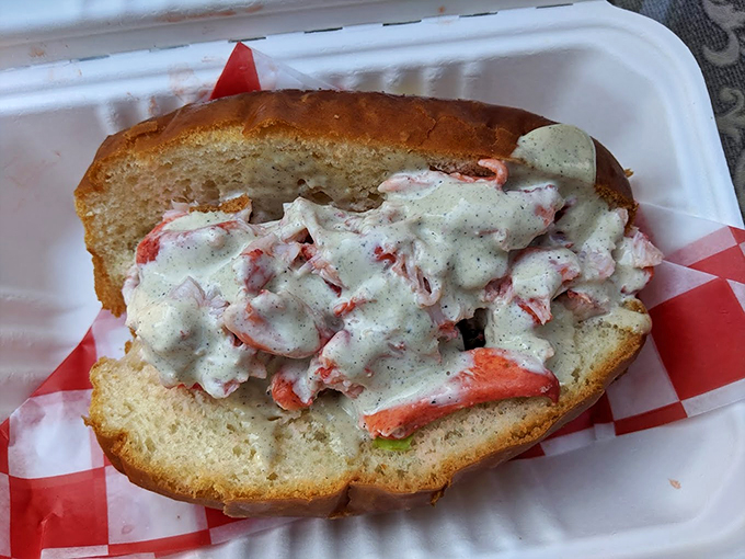 A classic Maine lobster roll that's dressed to impress, wearing its mayo like a perfectly tailored suit.