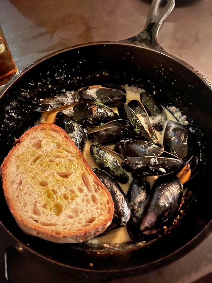 These mussels in white wine sauce, served with grilled bread, are what seafood dreams are made of. Photo credit: Yara F.