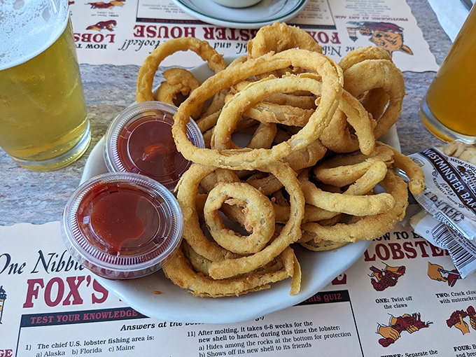 Onion rings that could double as golden bracelets. Crispy, light, and impossible to eat just one.