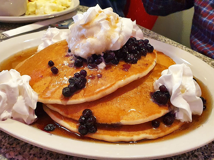Blueberry pancakes topped with whipped cream clouds &ndash; proof that sometimes the best things in life come stacked three high. Photo credit: Mark Juhrig