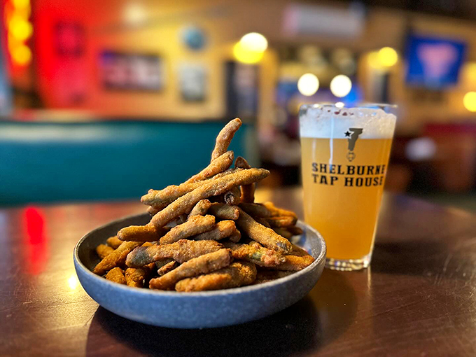 Crispy pickle fries that'll make you forget regular fries exist, paired with a golden glass of happiness.