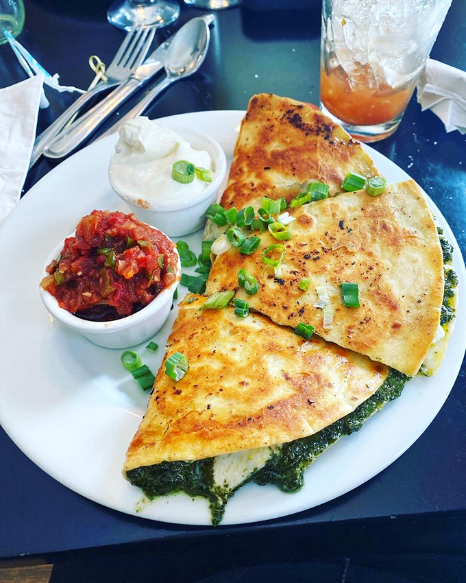 A quesadilla that's gone to finishing school, dressed up with fresh scallions and served with house-made salsa.